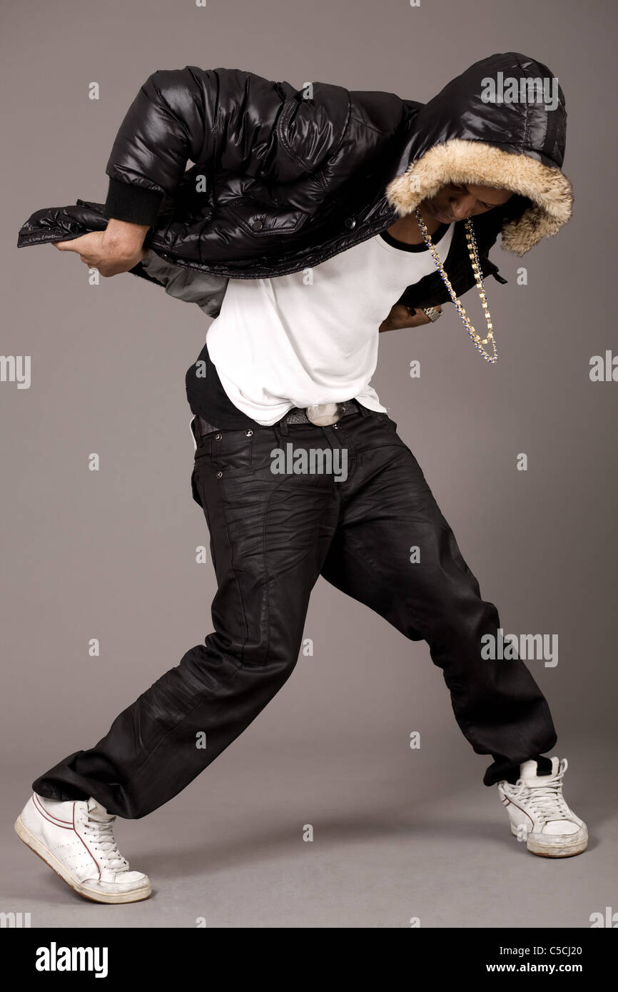 Man performs hip pop steps on grey background Stock Photo - Alamy
