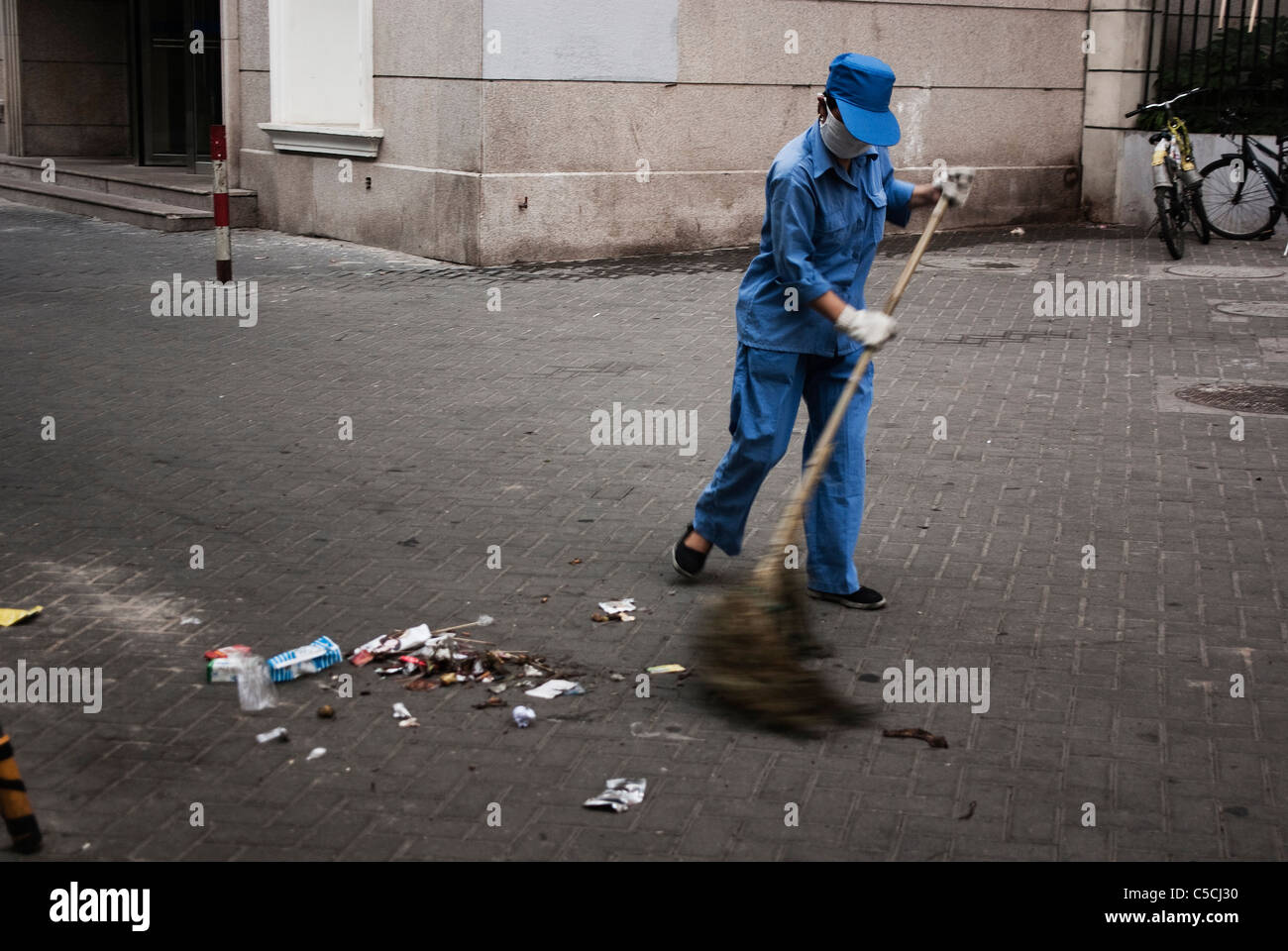 street cleaner brooming up rubbish in shanghai,china Stock Photo - Alamy