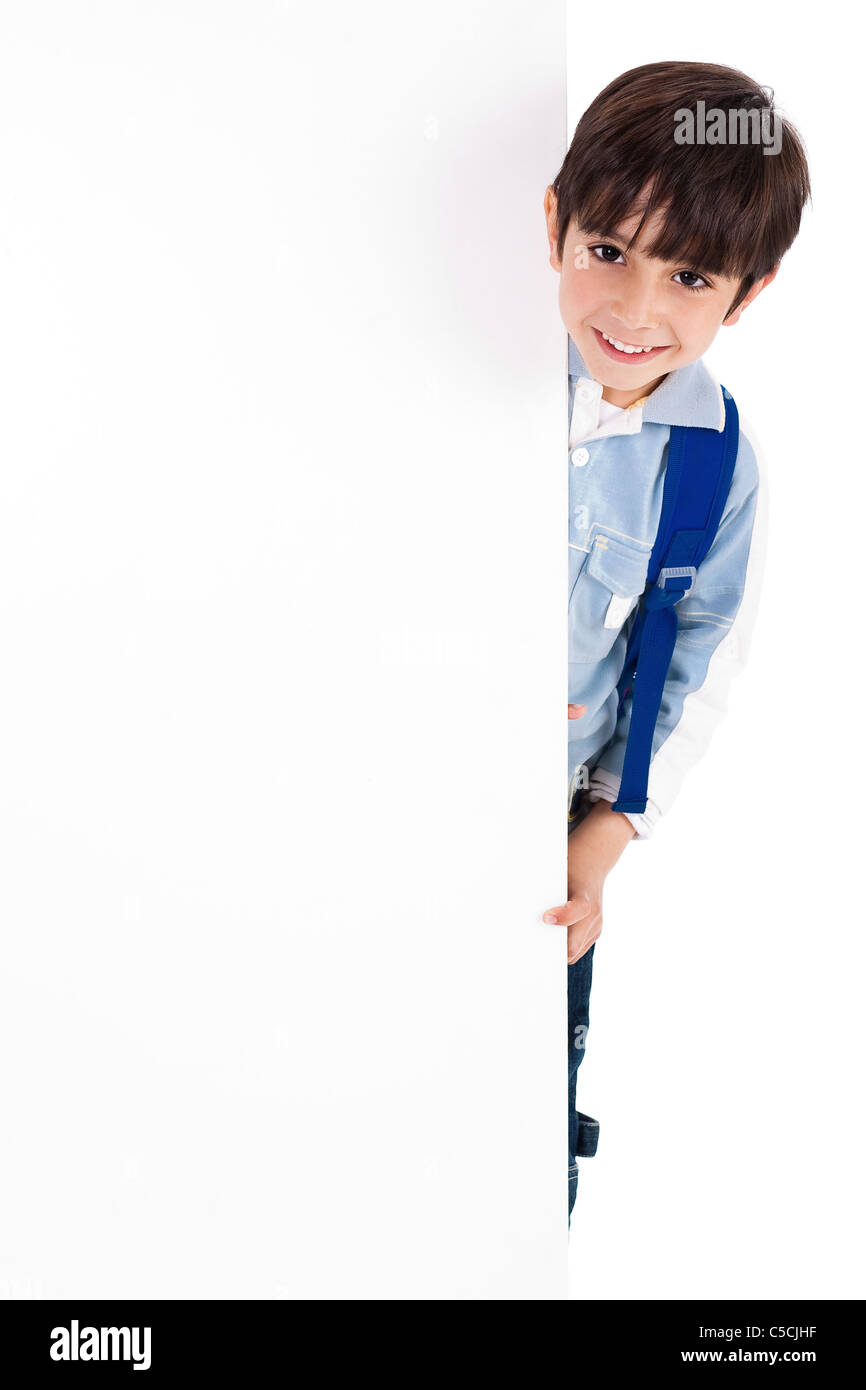 Young kid silently standing behind the board on white isolated ...