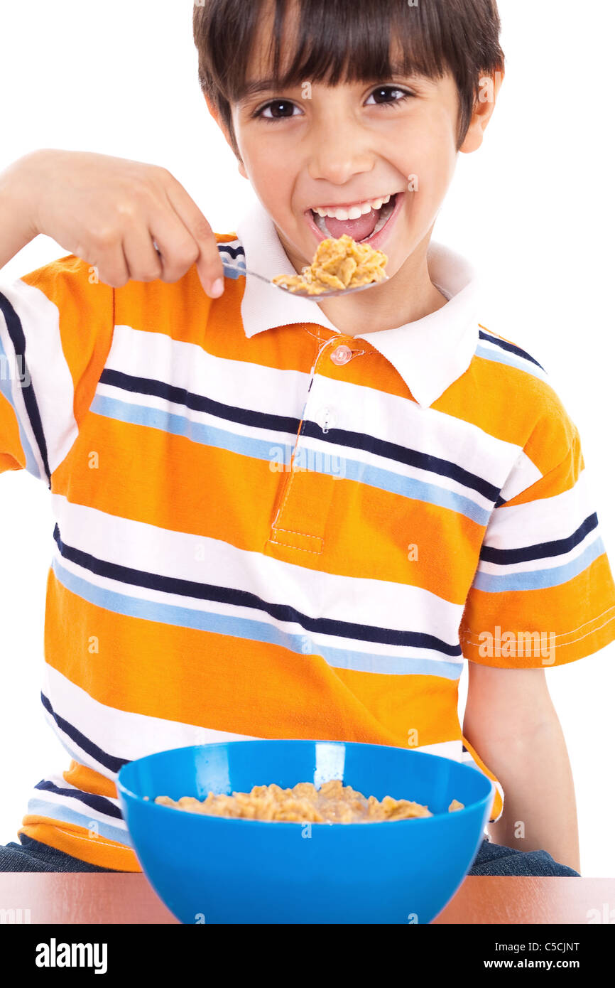 Young boy having his breakfast on isolated white background Stock Photo ...