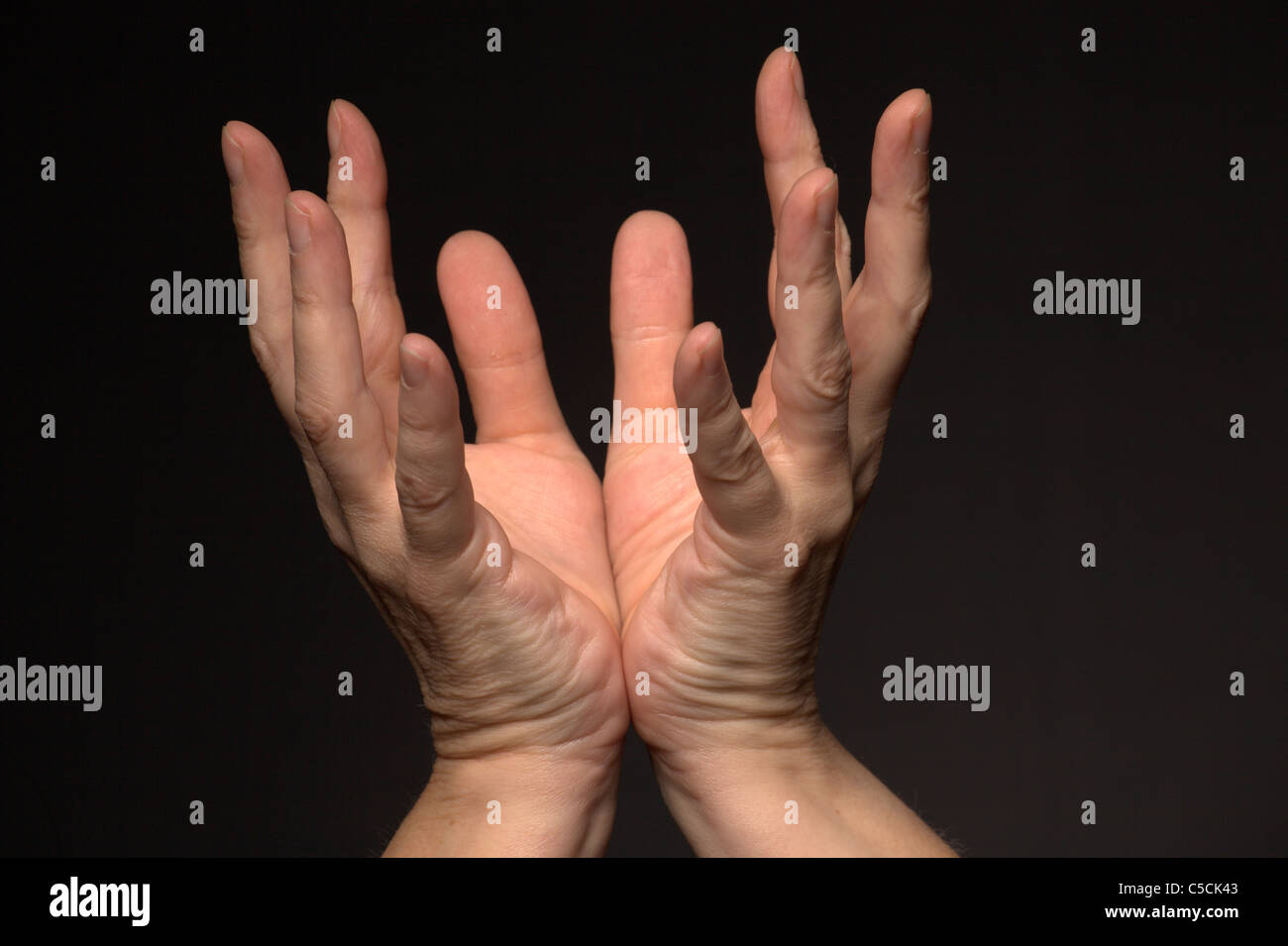 Open hands reaching skywards Stock Photo - Alamy