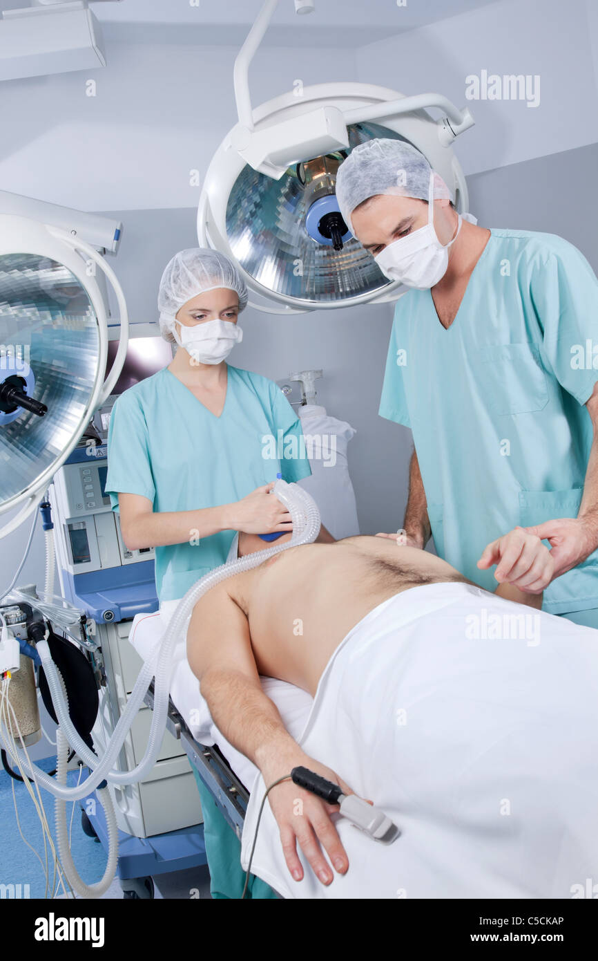 Nurse and doctor preparing the patient for an operation in a hospital ...