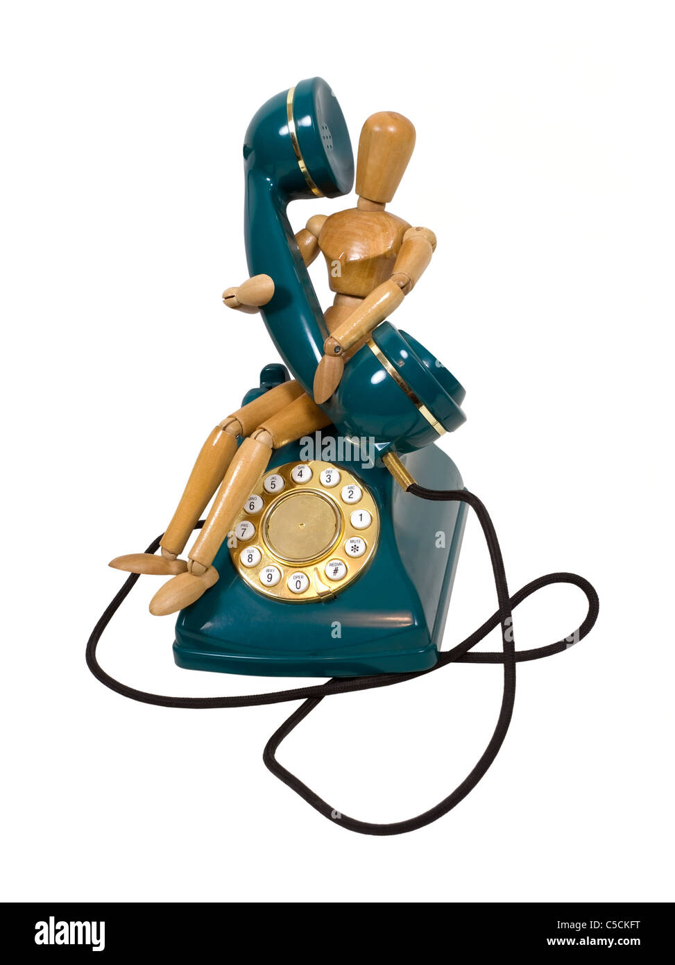 Traditional desk phone with rotary dial held by a model taking a call ...