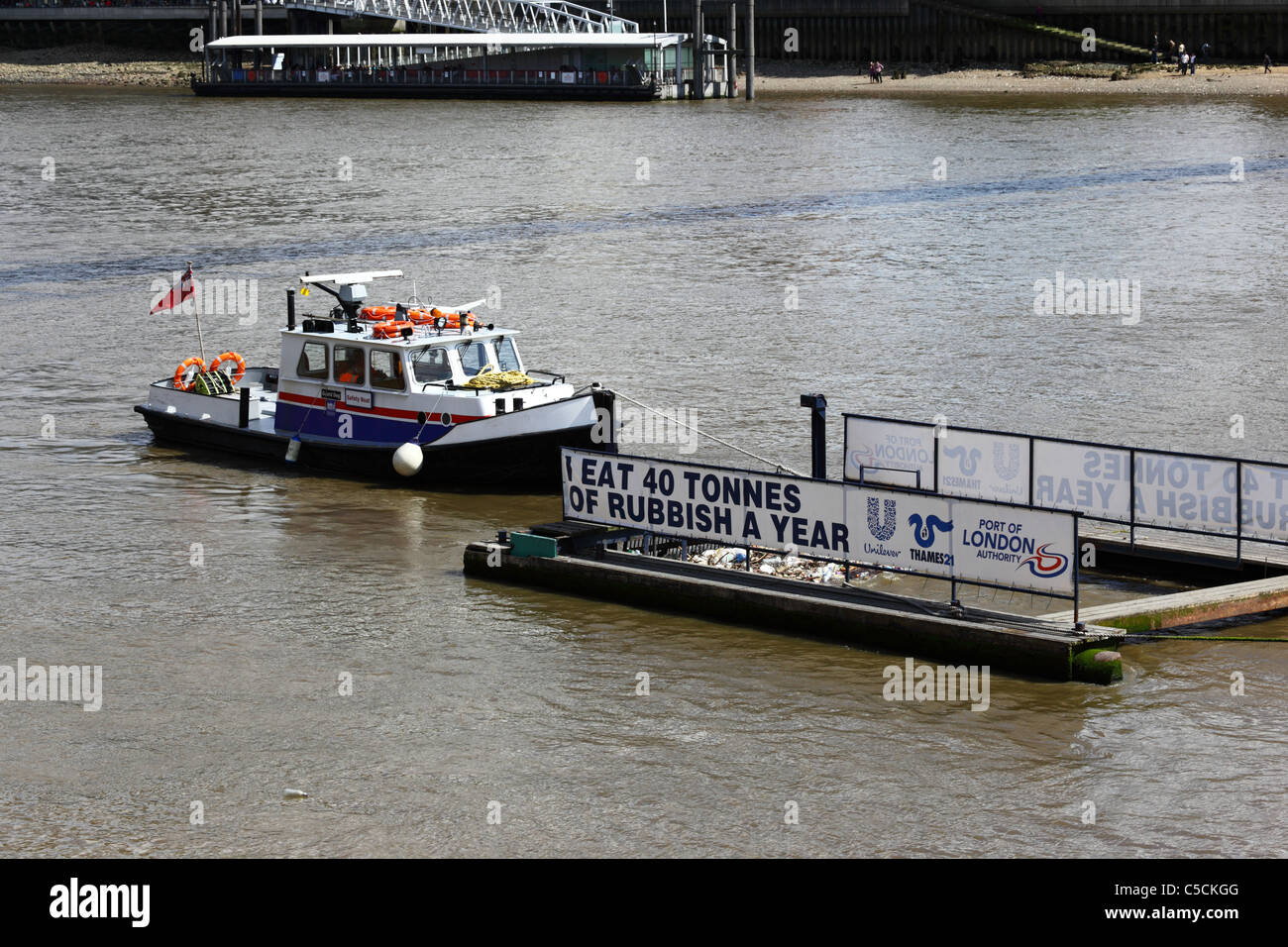 Rubbish collecting barge floating on River Thames near Blackfriars ...