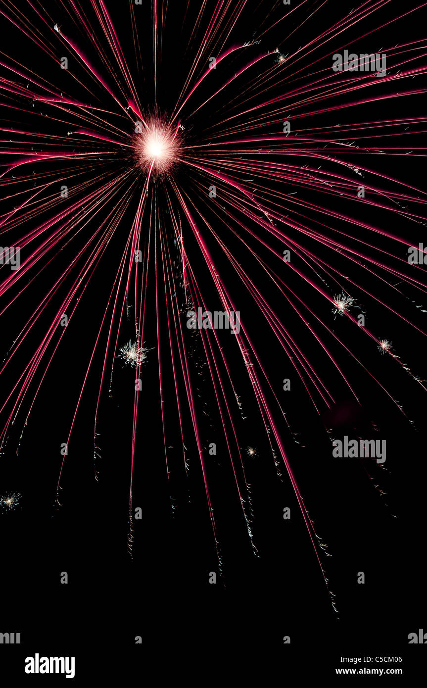 Red fireworks exploding in the night sky. A celebration of color and ...