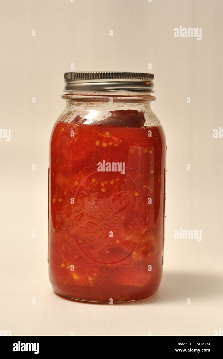A jar of home made tomato relish sits on a white background Stock Photo ...