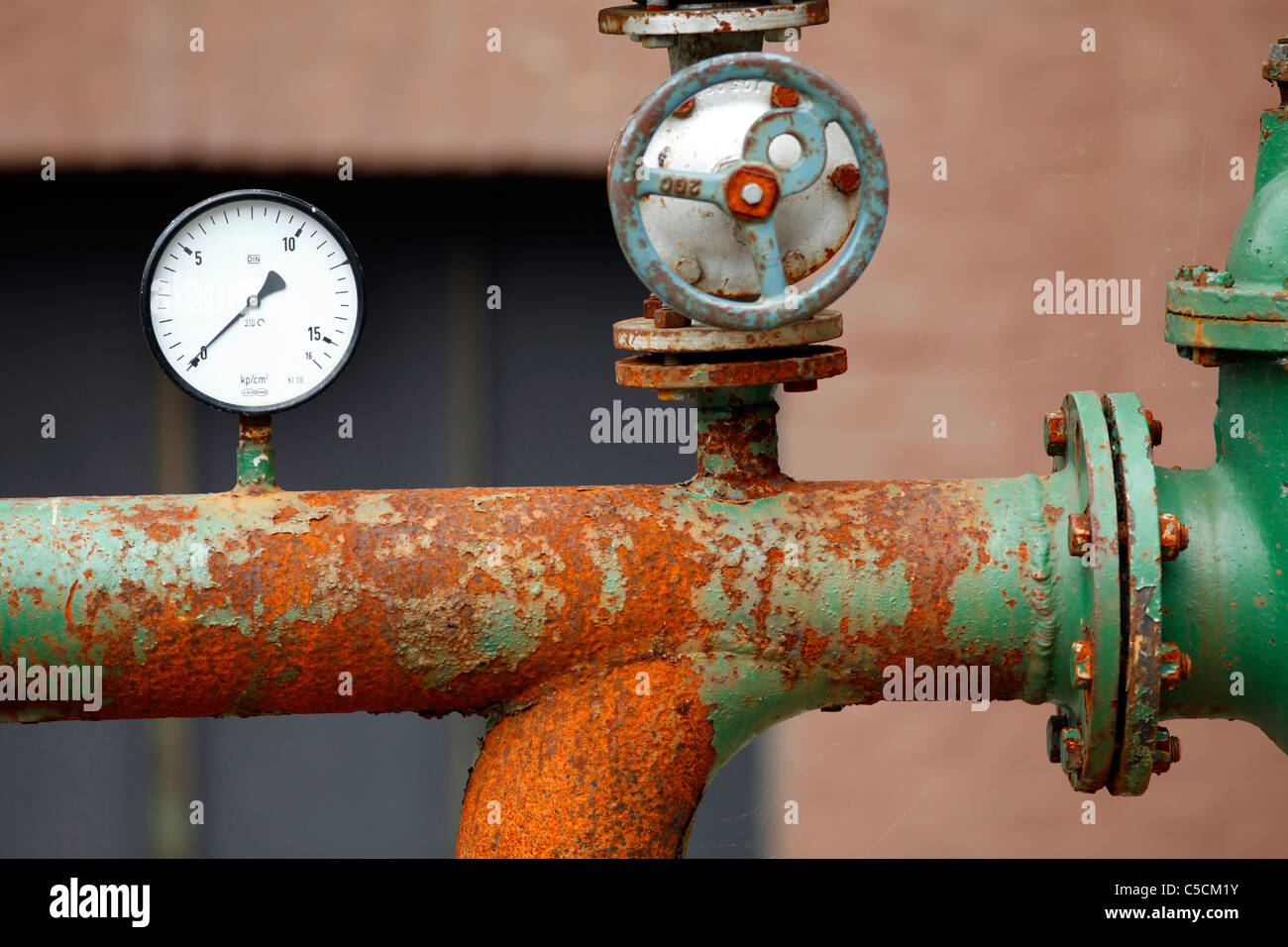 Old and rusty pipes and pressure indicator, of an old and closed ...