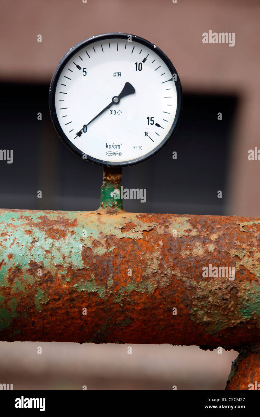 Old and rusty pipes and pressure indicator, of an old and closed ...