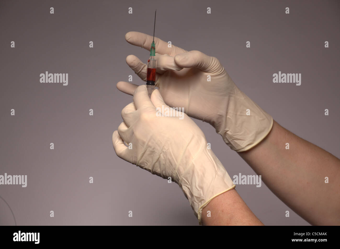 injection technique in gloved surgical hands Stock Photo - Alamy