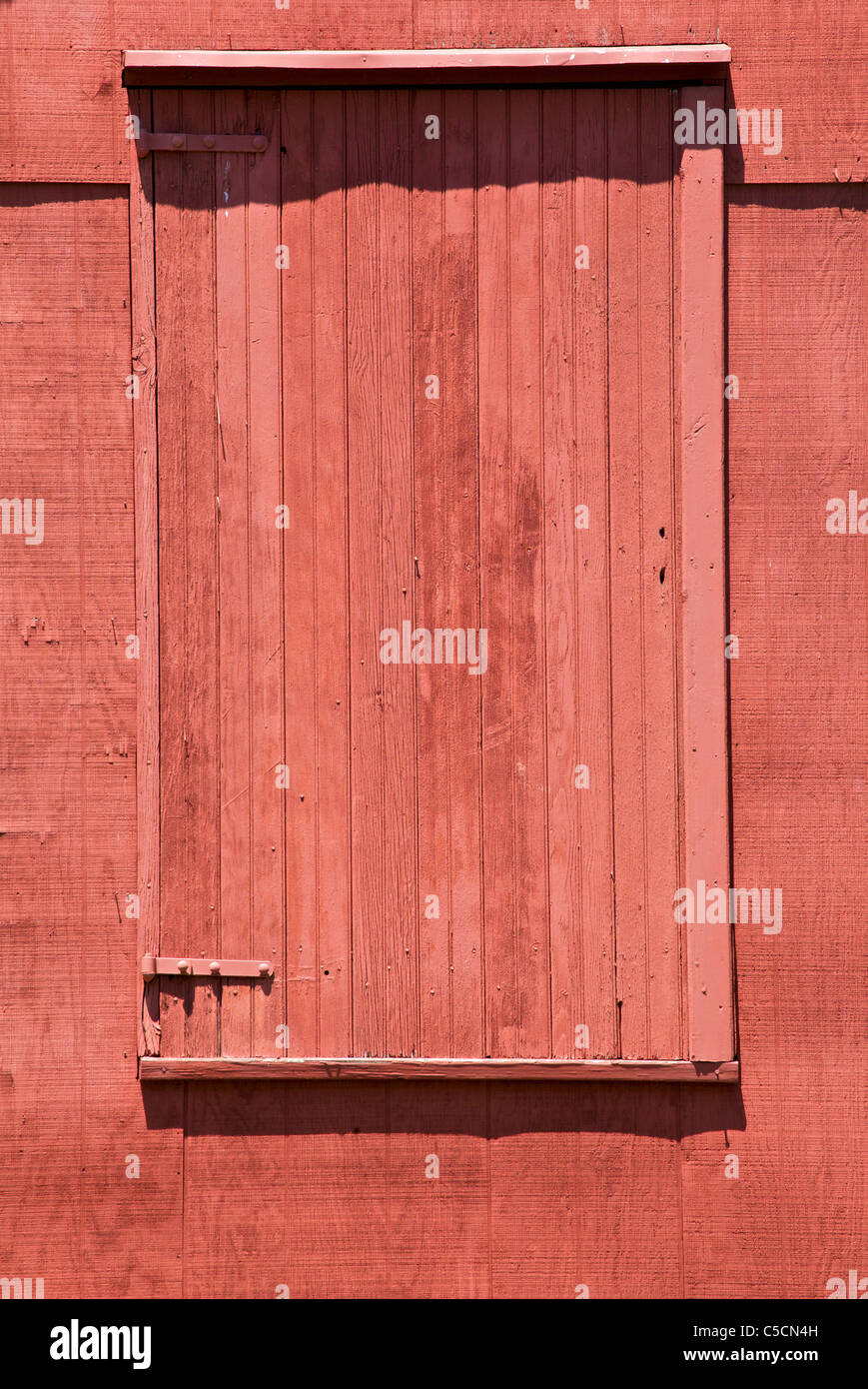 Red Barn Door with Red Iron Hinges Stock Photo - Alamy