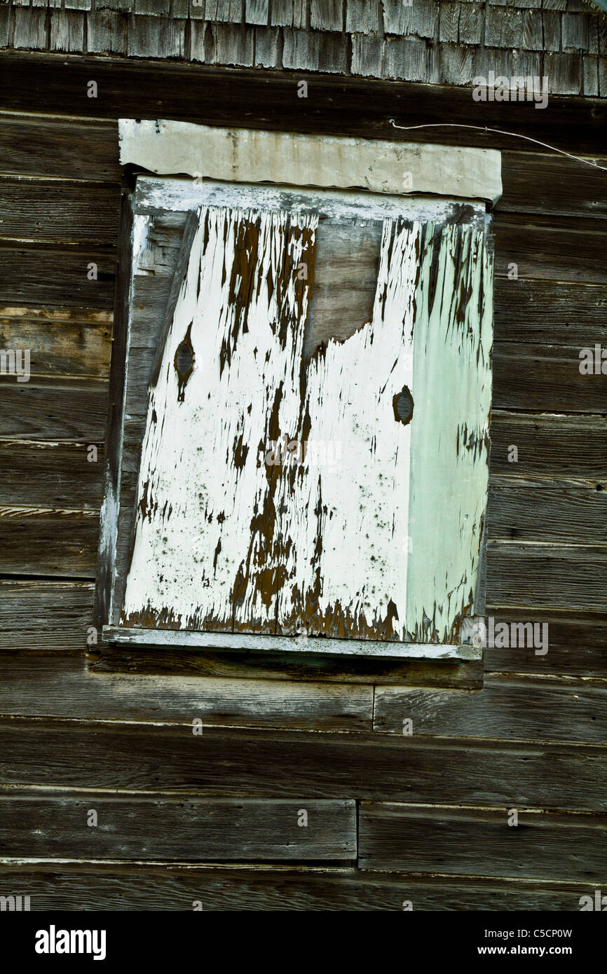 Rustic farm window covered with old paint chipped wood Stock Photo - Alamy