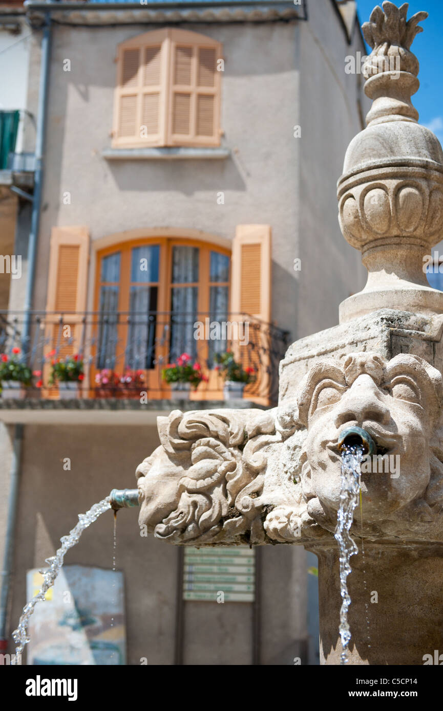 Romantic French fountain spouting water in little village Stock Photo ...