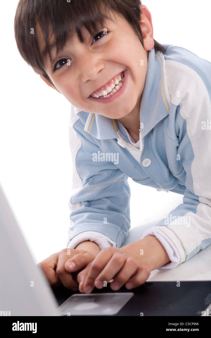 Portrait of cute caucasian boy smiling with laptop over white ...