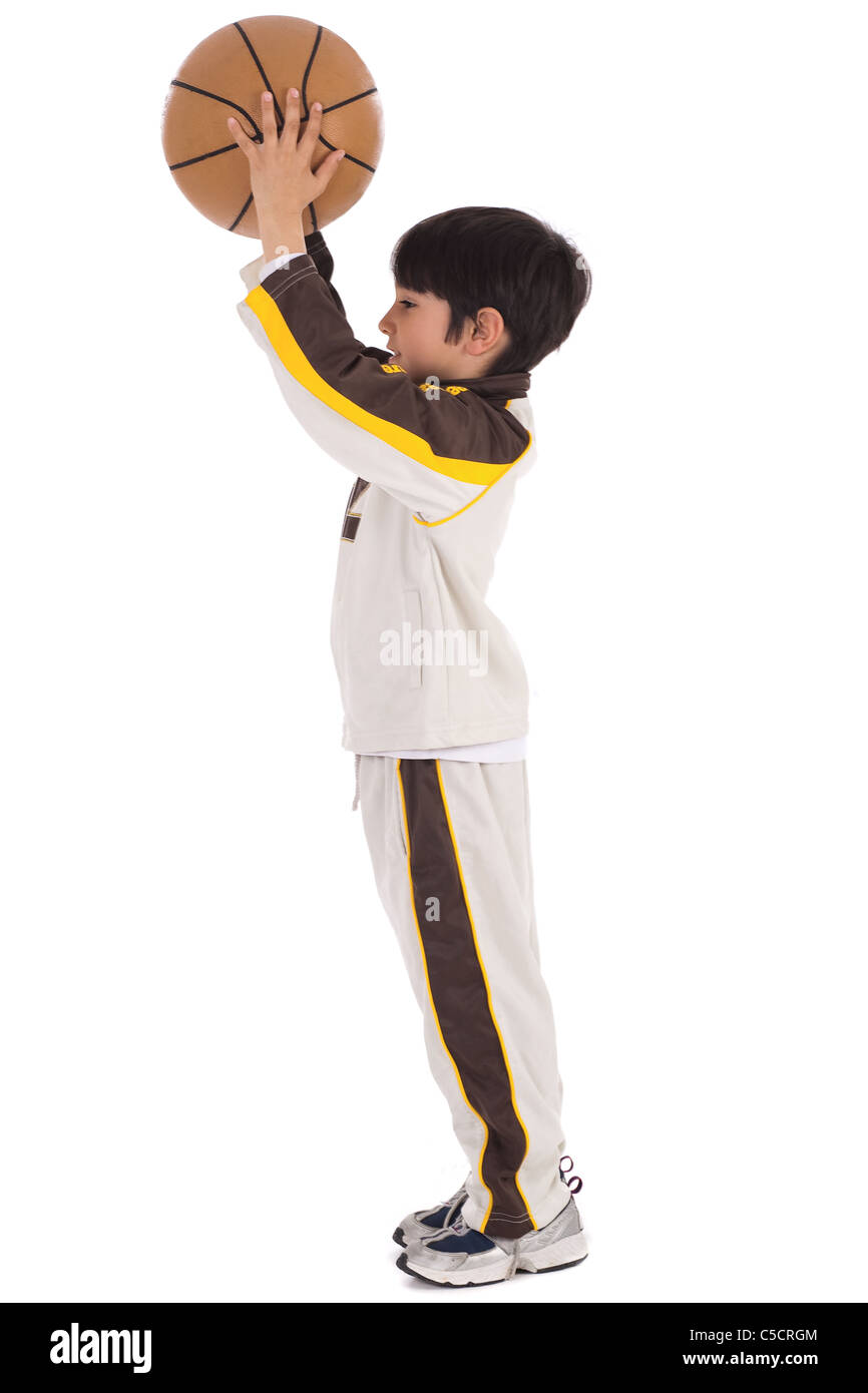Little kid while throwing the basketball on white isolated background ...