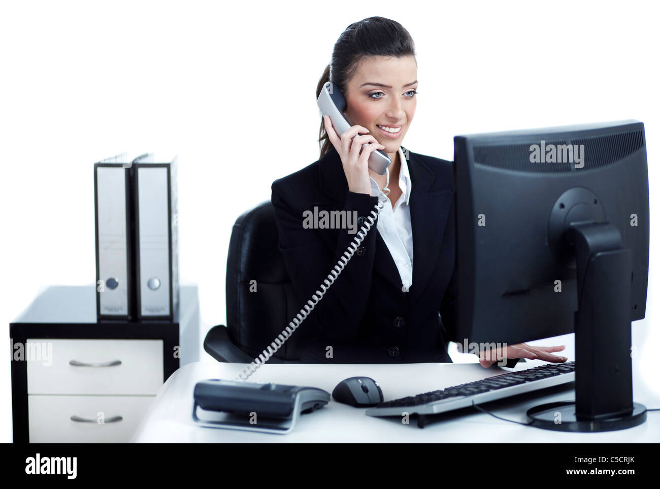 Young and pretty business woman talking over phone on white background ...