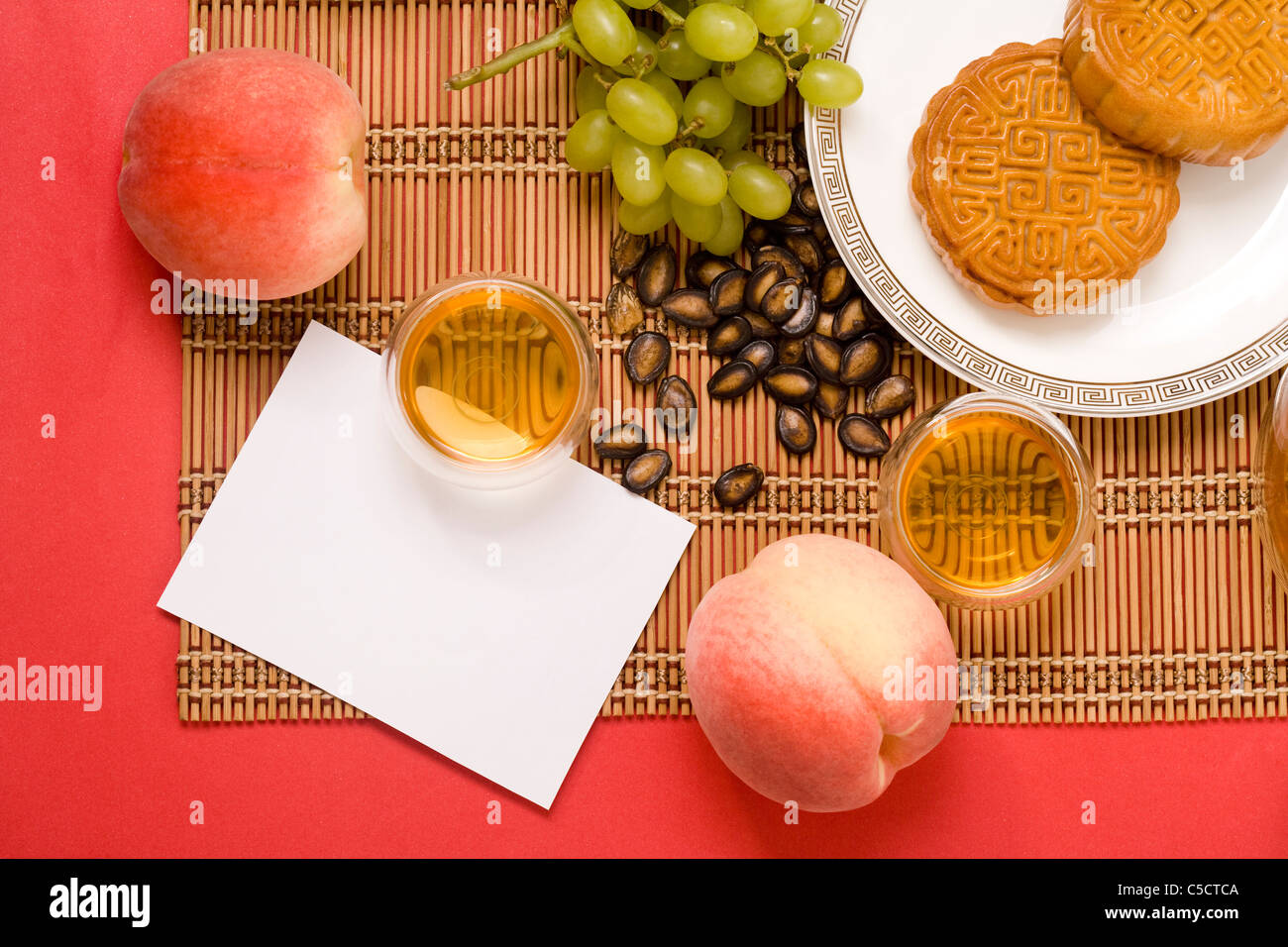 Moon Cakes with Fresh Fruit, Seeds, and Tea Stock Photo - Alamy