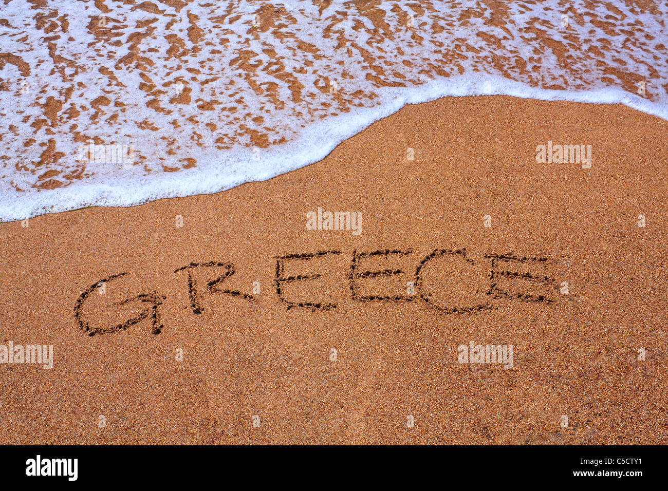 Writing on the sand with water coming to erase it Stock Photo - Alamy