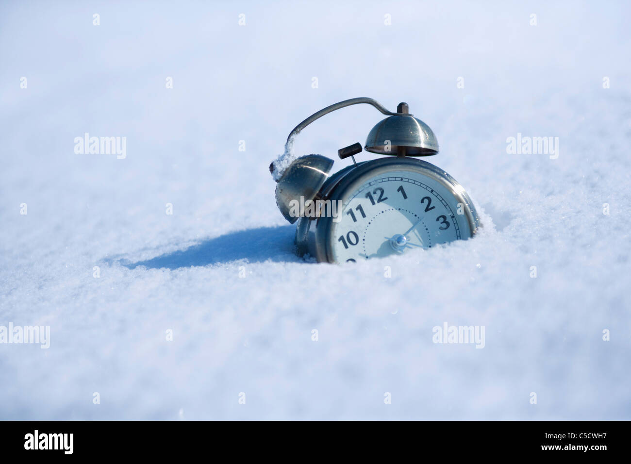 clock in snow field Stock Photo - Alamy