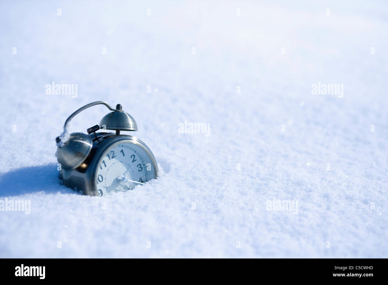 clock in snow field Stock Photo - Alamy