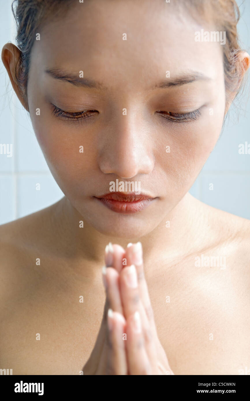 Closeup portrait of a young woman praying Stock Photo - Alamy
