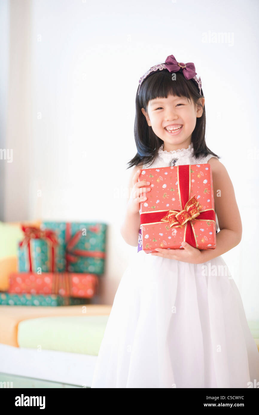girl got present wearing white dress Stock Photo - Alamy