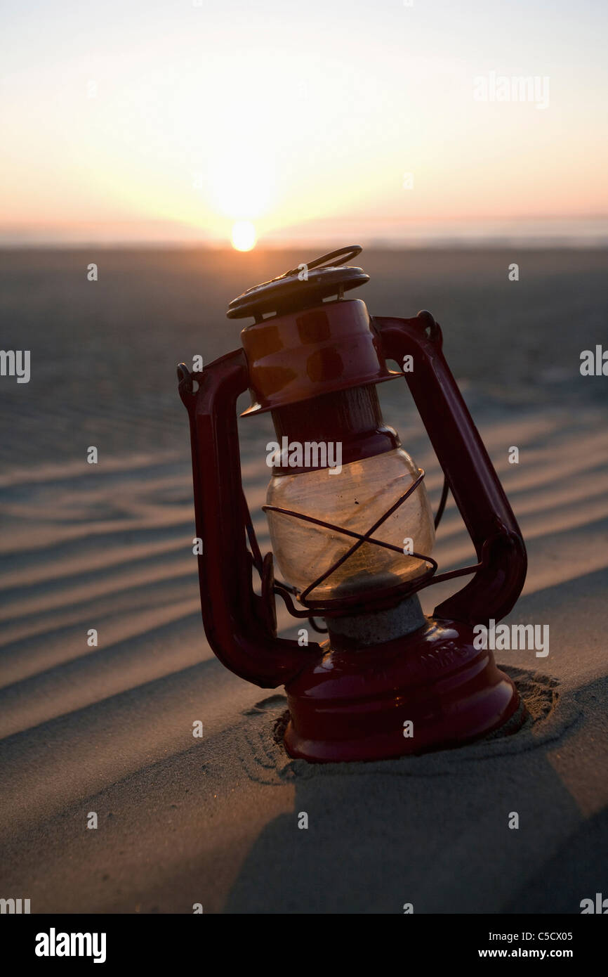 lamp on the beach under the sunset glow Stock Photo - Alamy