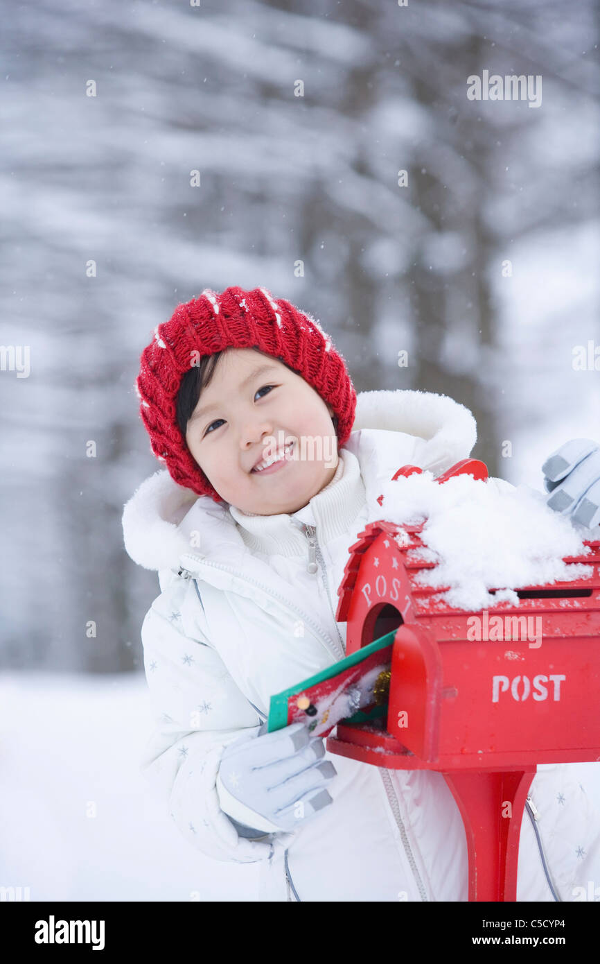 girl put the letter in post box Stock Photo - Alamy