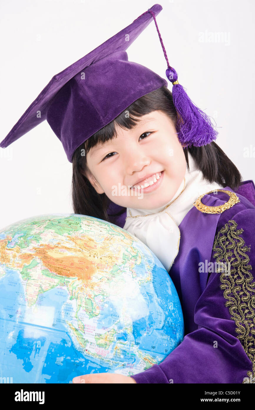 girl in graduation cap and gown hugging globe Stock Photo - Alamy