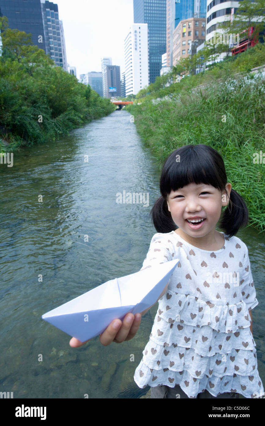 girl holding a paper boat Stock Photo - Alamy