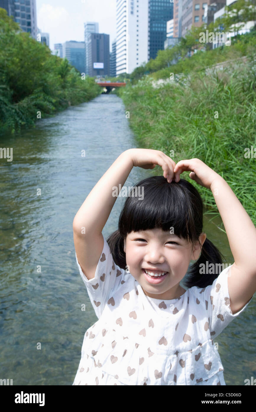 girl making heart shape with her arms Stock Photo - Alamy