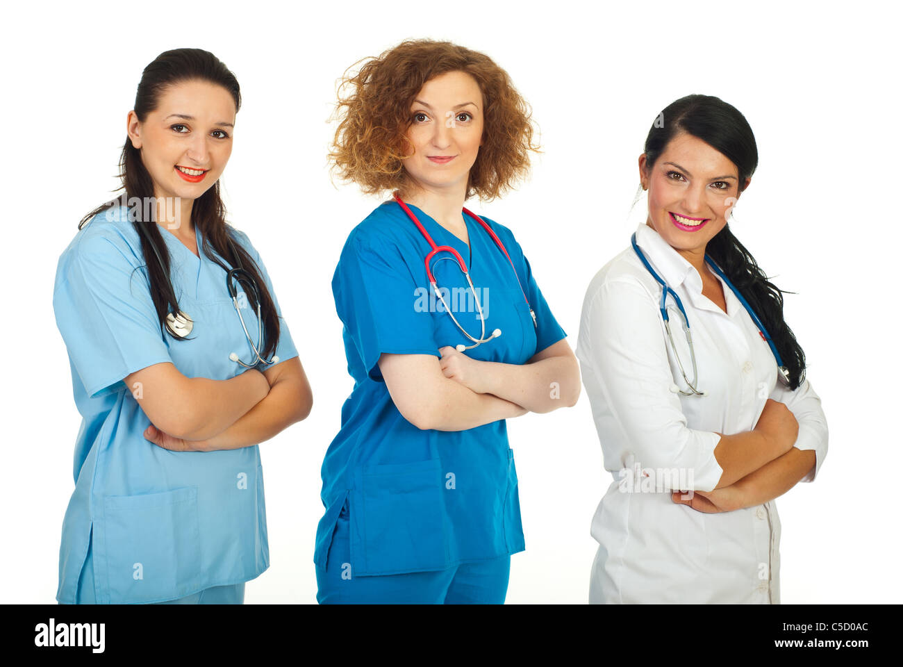 Friendly team of three doctor women in different uniforms standing in ...