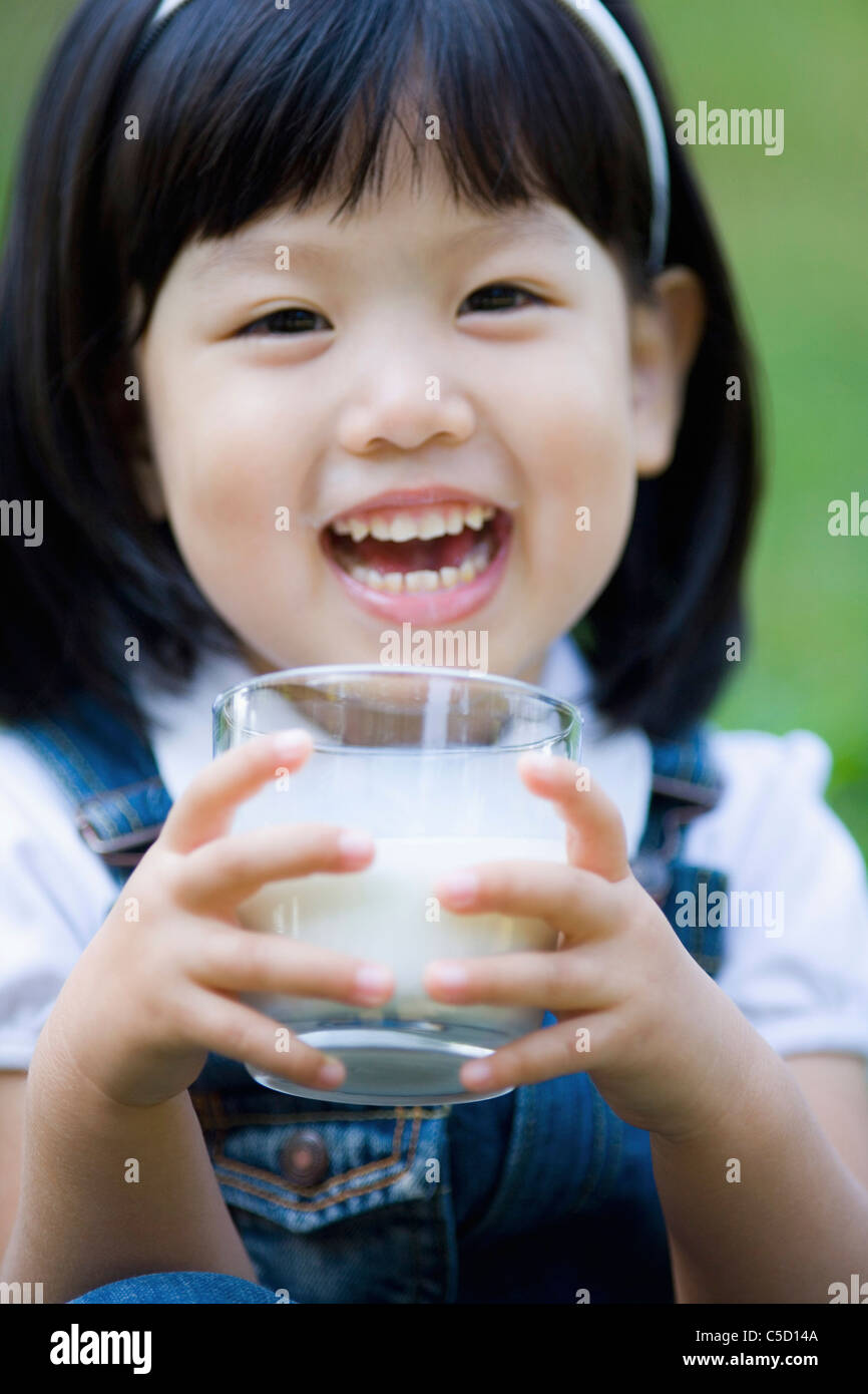 girl holding cup of milk Stock Photo - Alamy