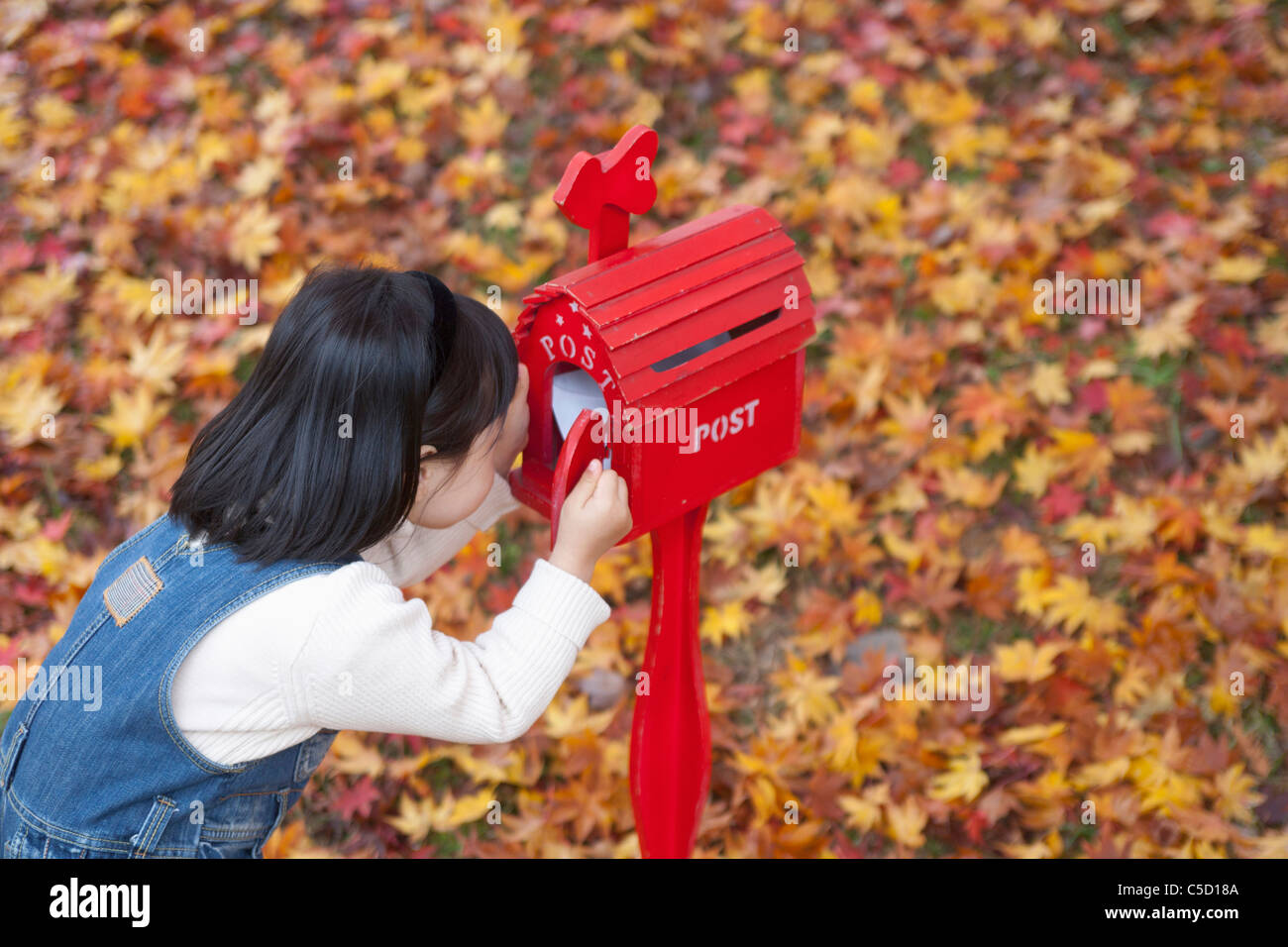 girl looking in post box Stock Photo - Alamy