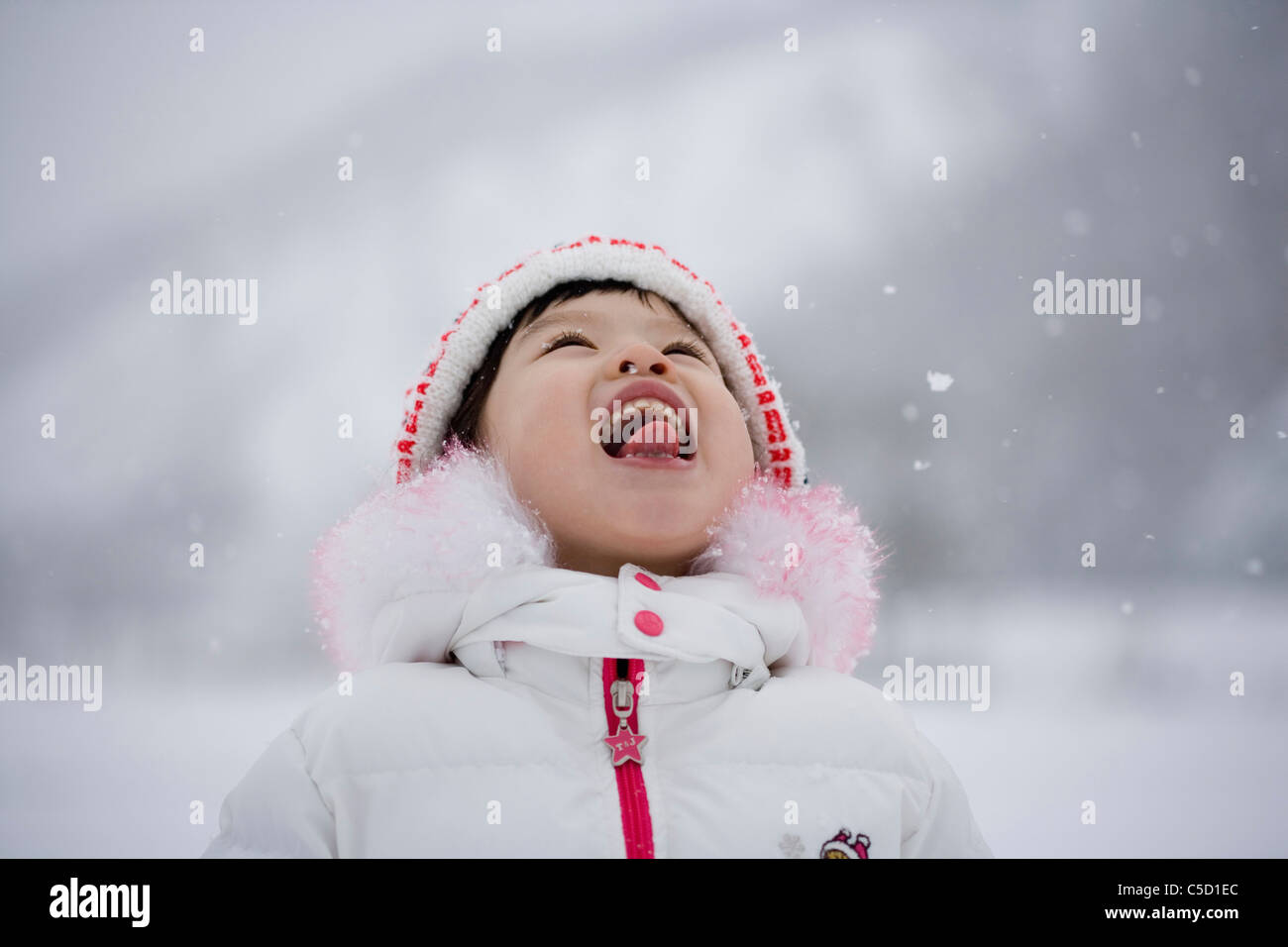 girl stick her tongue out to eat snow Stock Photo - Alamy