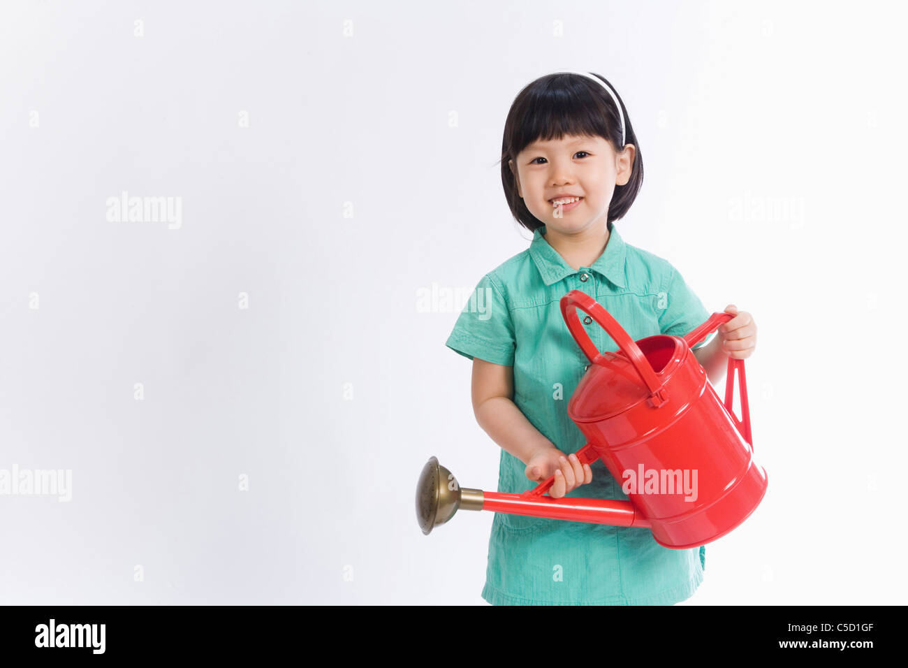 girl holding watering can Stock Photo - Alamy