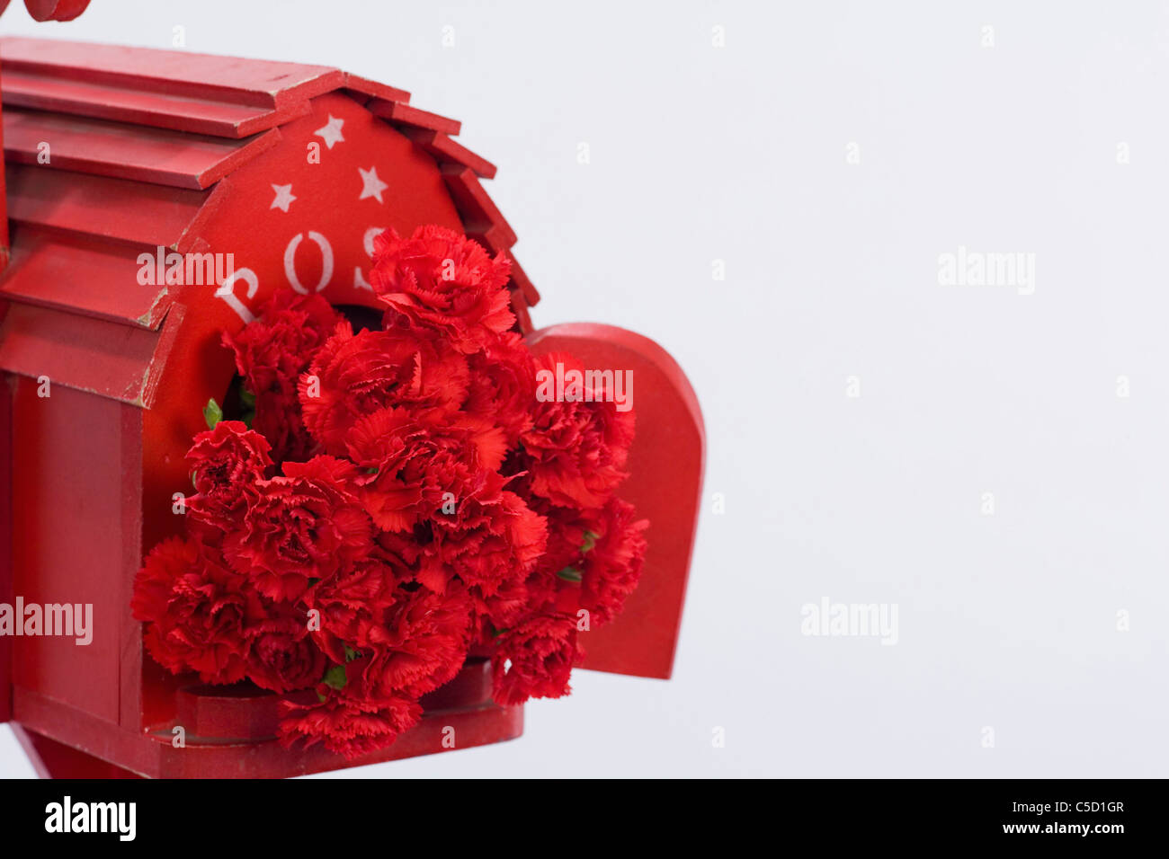red carnations in post box Stock Photo - Alamy