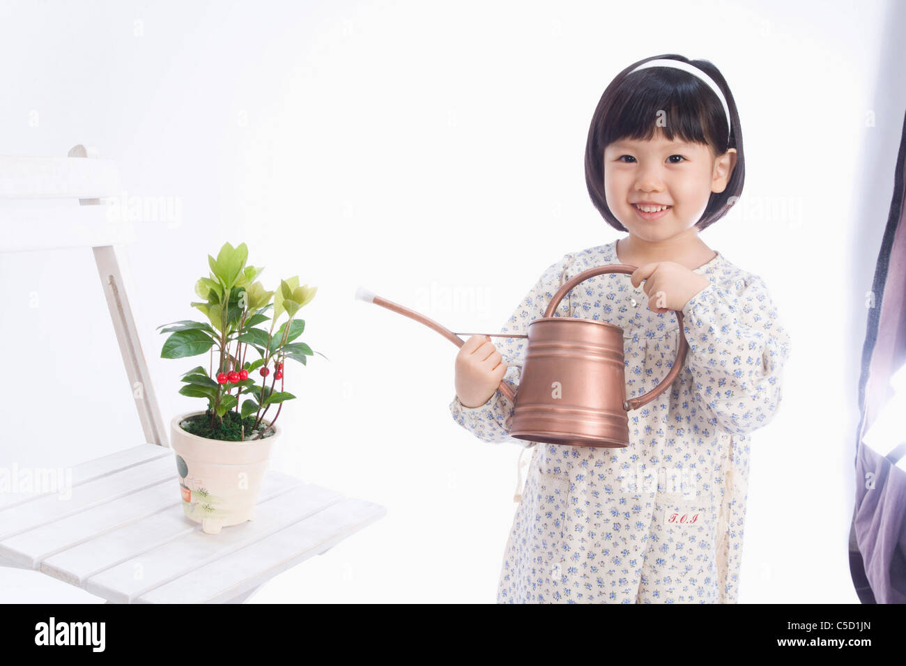 girl holding watering can Stock Photo - Alamy