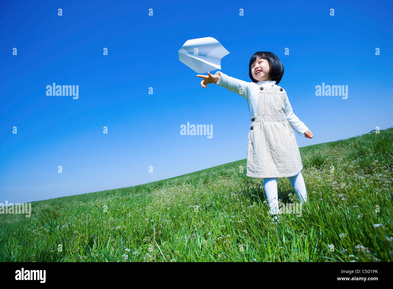 girl flying paper airplane Stock Photo - Alamy