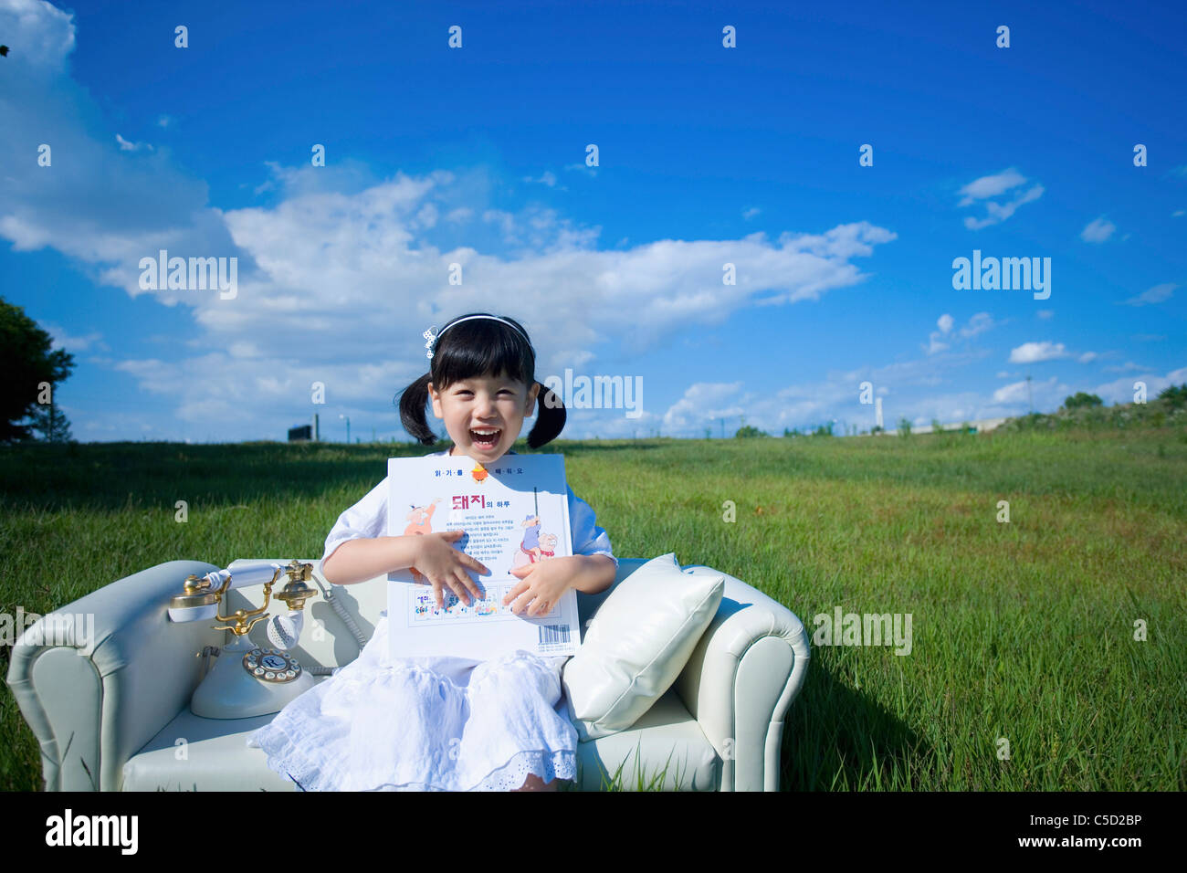 girl laughing hugging book Stock Photo - Alamy