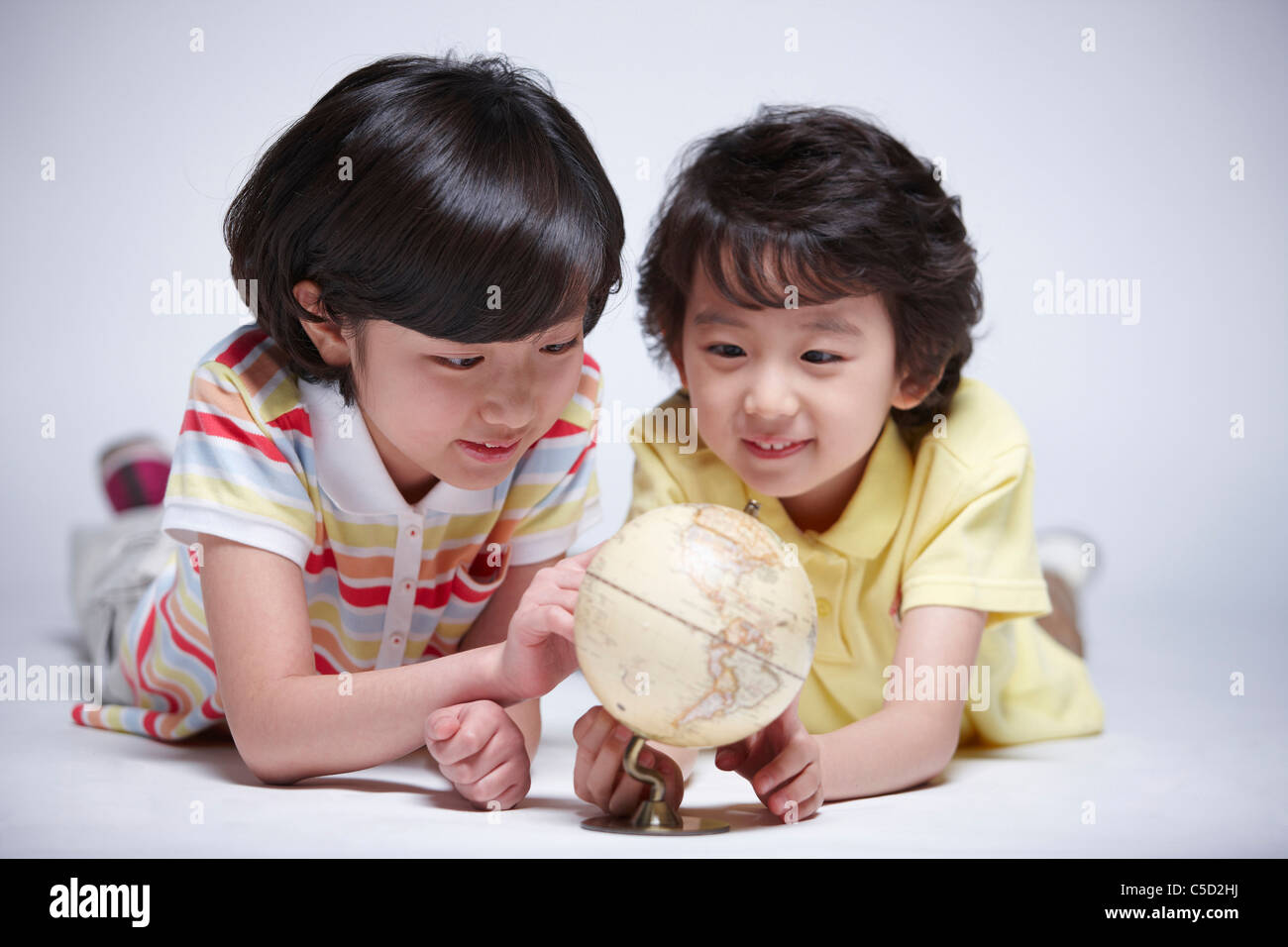 children education touching globe Stock Photo - Alamy