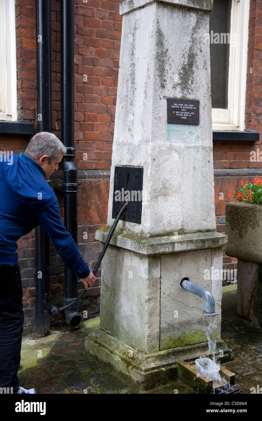 Old man pumping water pump hi-res stock photography and images - Alamy