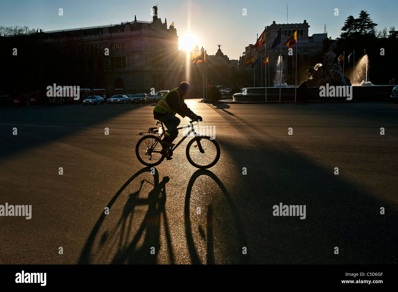 Man riding a bike as the sun rises, Madrid, Spain Stock Photo - Alamy