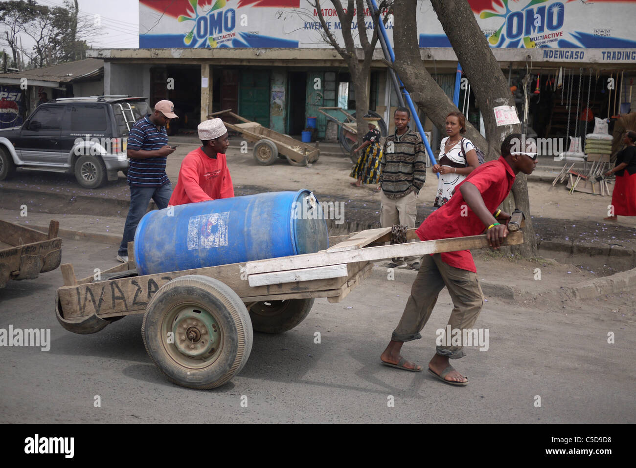 TANZANIA Man hauling a load of water, Arusha Stock Photo - Alamy