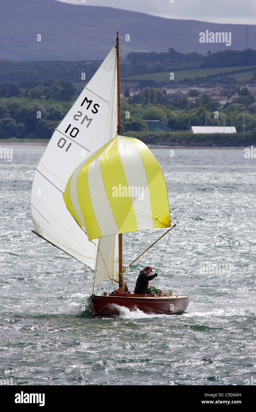 A sailing dinghy on the Menai Straits off Beaumaris on the Isle of ...