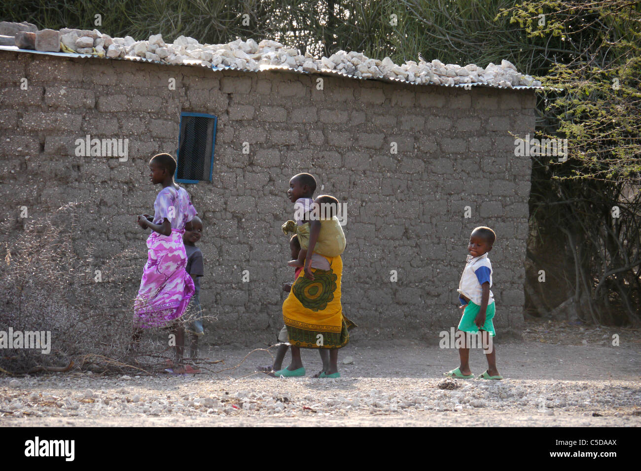 TANZANIA Village of Mwamalasa, Shinyanga. Children walking, some ...