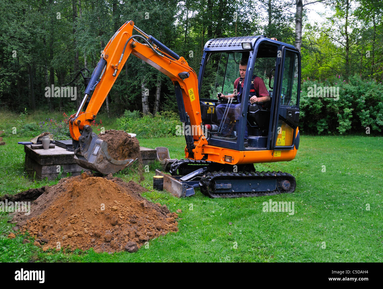 Mini excavator man garden hi-res stock photography and images - Alamy