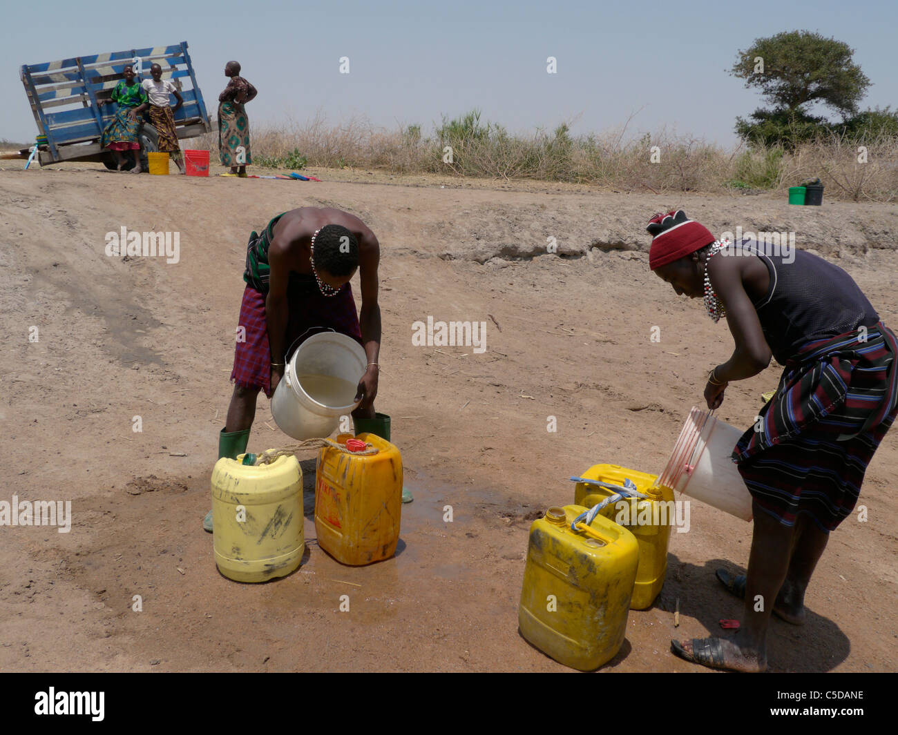 TANZANIA Watatulu tribes collecting water from a dry river bed in ...