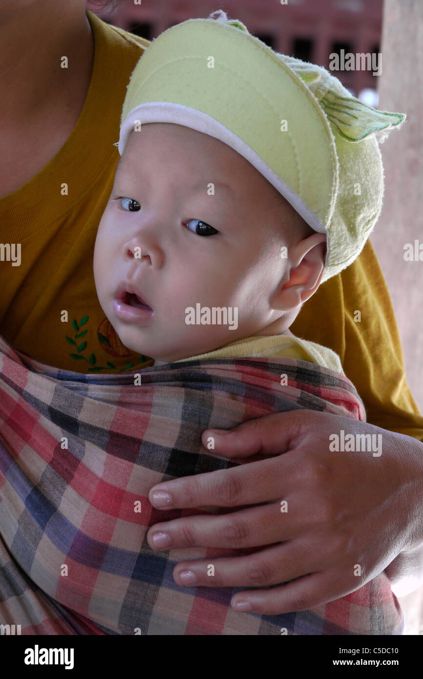 THAILAND Visit to Ban Pang Baou, a Catholic Lahu village. Lahu mother ...
