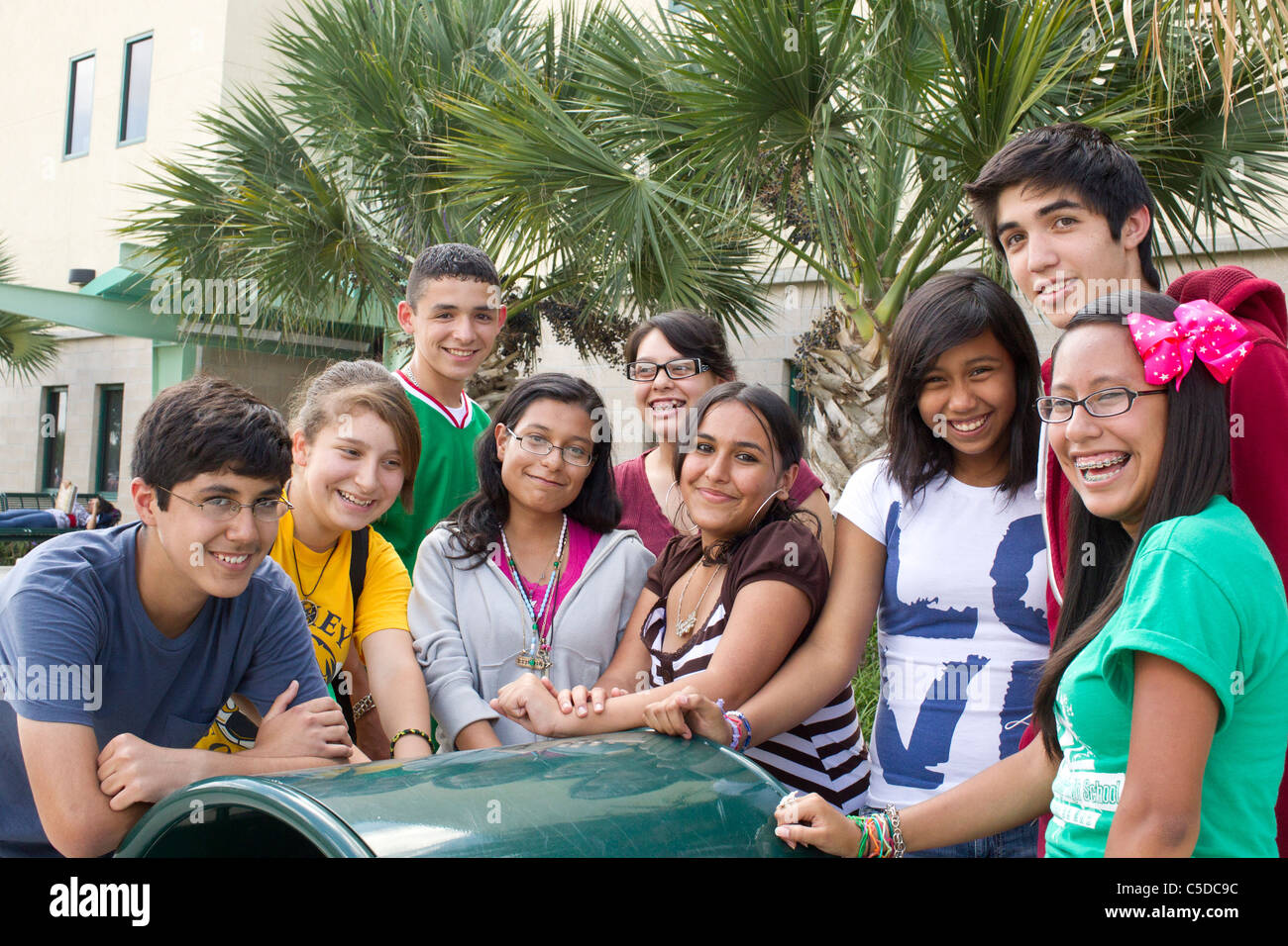 male and female high school students gather in courtyard in between ...