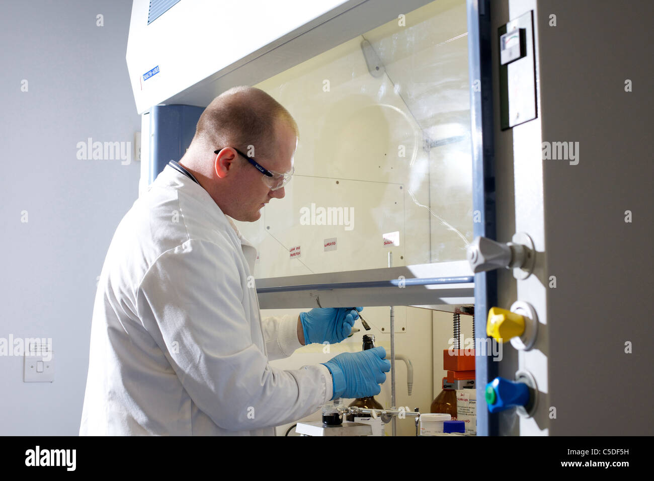 Lab technician checking samples at the Leeds Metropolitan University ...